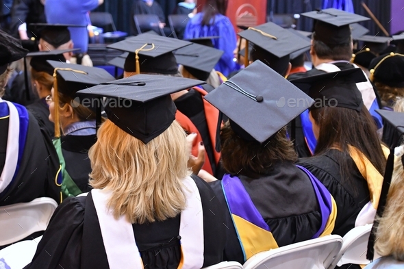Faculty and Staff wearing their caps and gowns from their universities ...