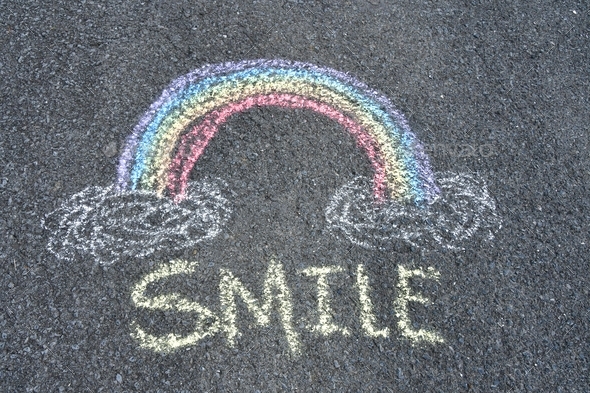 SMILE written in pastel sidewalk chalk with a colorful rainbow Stock ...