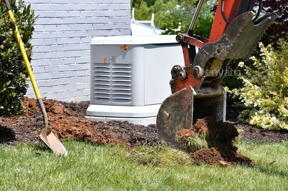 Backhoe digging dirt in lawn to install electrical & gas lines for ...
