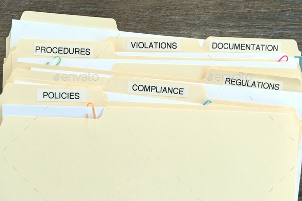 File Folders with words Compliance, Policies, Regulations, Violations ...