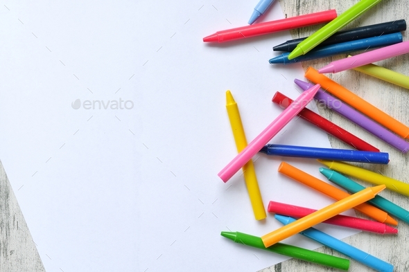 Bright colorful generic crayons on blank white paper. vivid colors ...