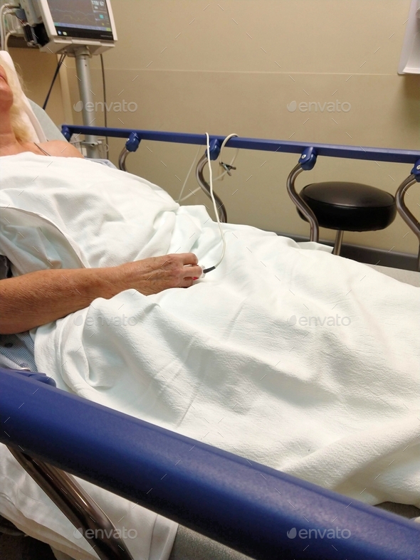 A female patient laying in a hospital bed gurney in ER Emergency Room ...