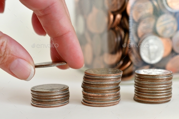 Stacking quarters to count my savings of loose change - hand in frame ...