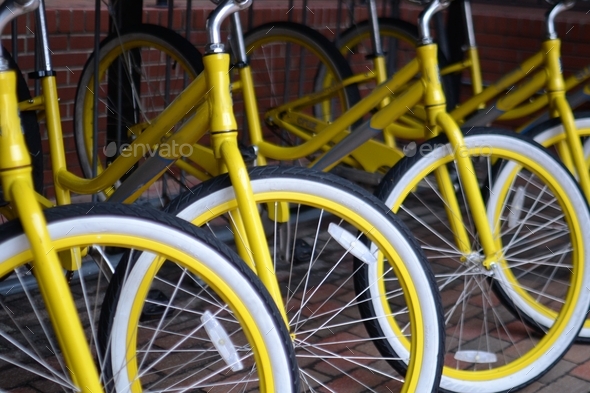 Bright yellow bikes all in a row. Repeating pattern Stock Photo by ...