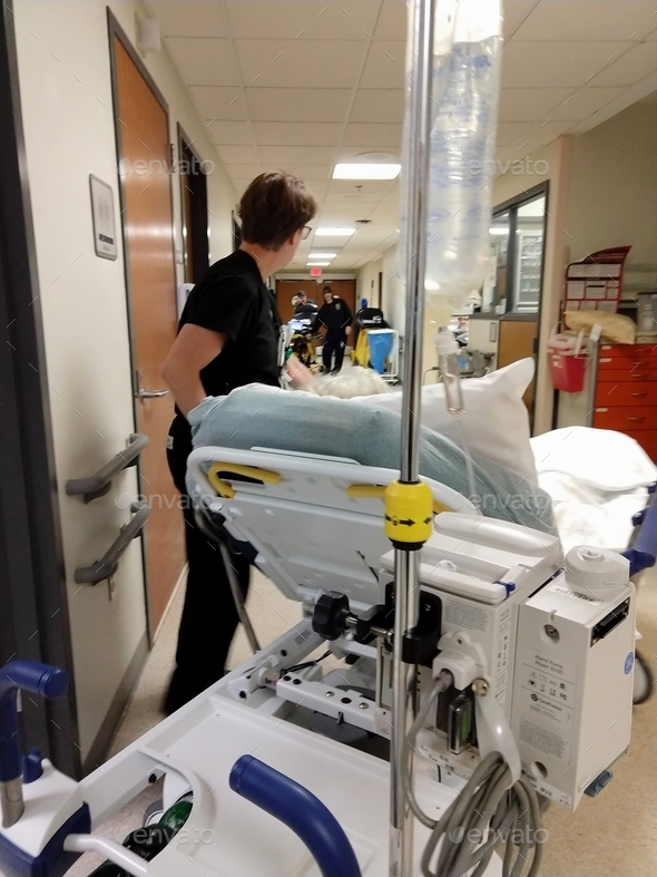 A patient being pushed on a gurney through a hospital ER Emergency Room ...