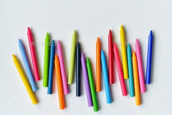 Row bright colorful generic crayons on blank white paper vivid colors ...