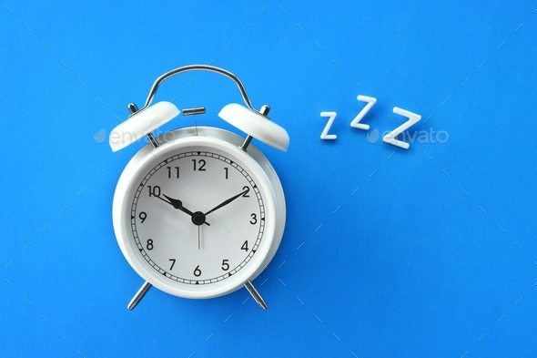 Alarm clock with ZZZ - concept sleep, bedtime, dreams, REM sleep, time ...