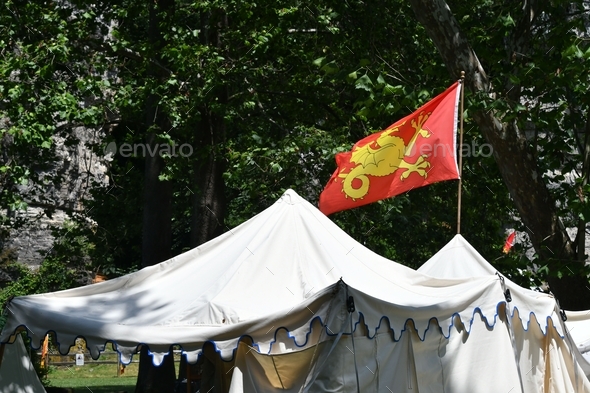Flag or banner flying over a tent at Renaissance Fair Faire, make ...