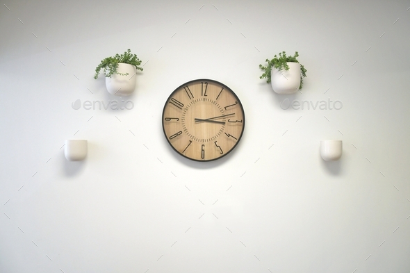Minimal wall arrangement of clock and hanging succulent planters. Stock ...
