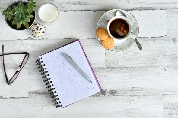 High angle view of a blank notepad journal diary on a light wooden desk ...