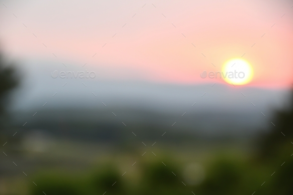 Out of focus sunset sunrise over the mountains for a natural neutral ...