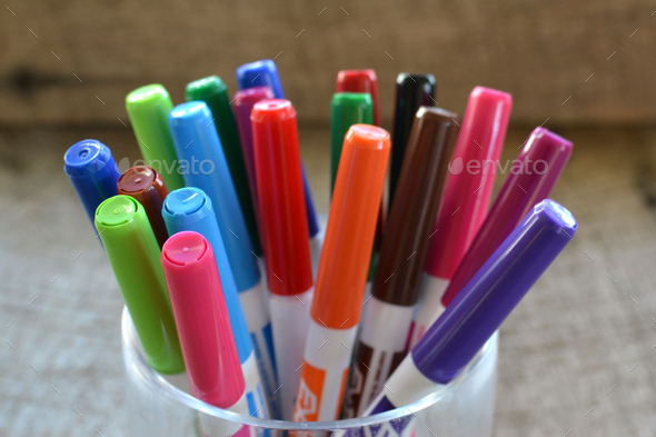 Colorful white board dry erase magic markers in a container on a desk ...