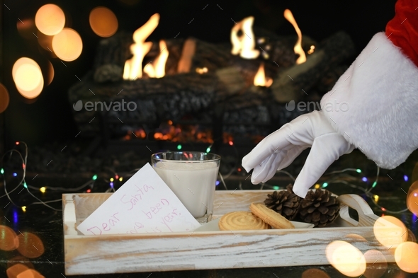 Santa on Christmas Eve - Santa Claus reaching to grab a cookie left out ...
