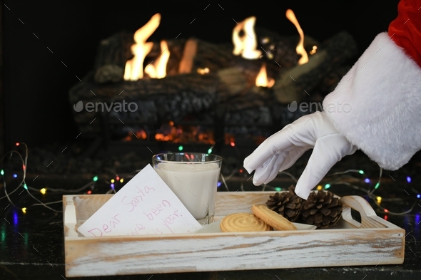 Santa on Christmas Eve - Santa Claus reaching to grab a cookie left out ...