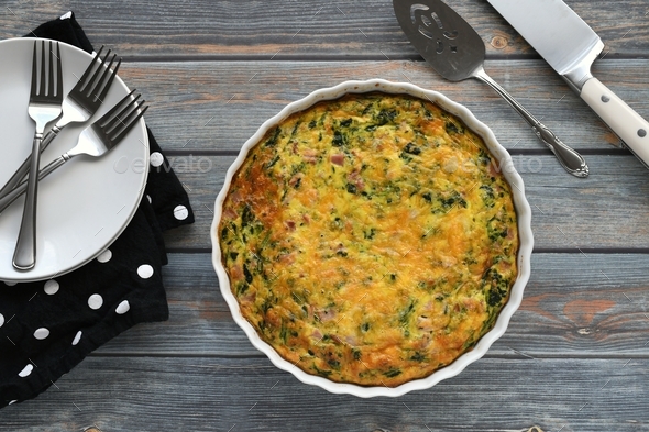 A ham, cheese & spinach quiche. Flat lay of cooked quiche on table for ...
