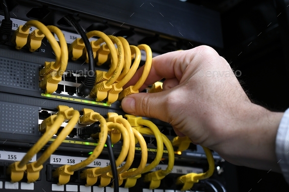 IT Department - cables wires connections to servers - IT guy making ...