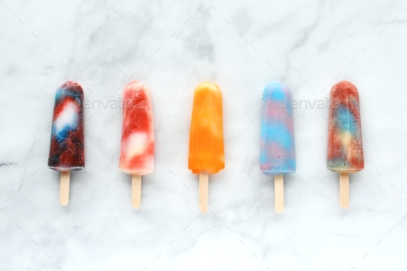 Row of colorful frozen swirled popsicles frozen summer treats dessert ...