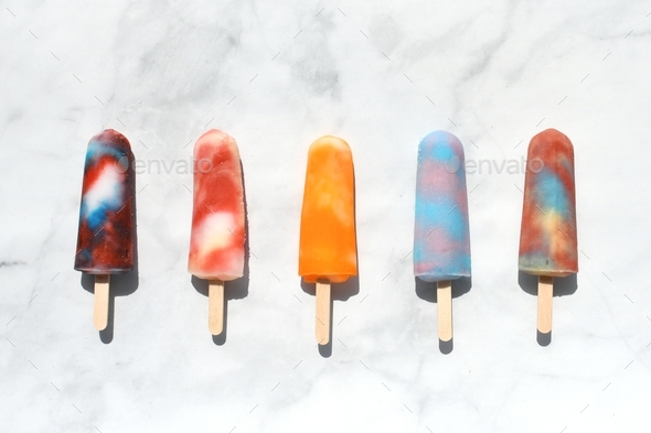 Row of colorful frozen swirled popsicles frozen summer treats dessert ...