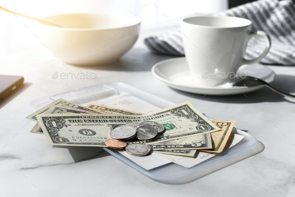 Paying for your bill tab at a restaurant cafe with cash money early ...