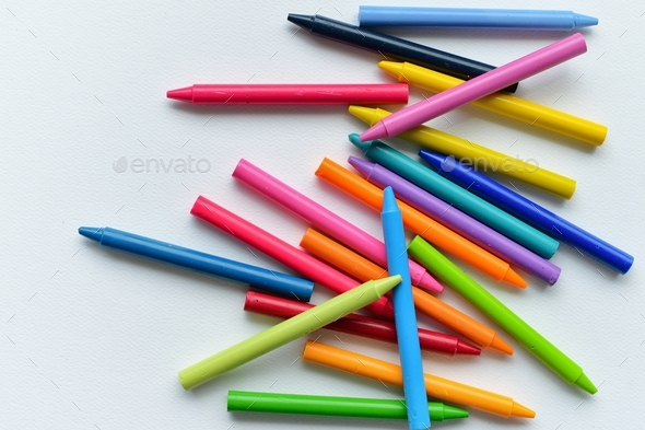 Bright colorful generic crayons on blank white paper. vivid colors ...