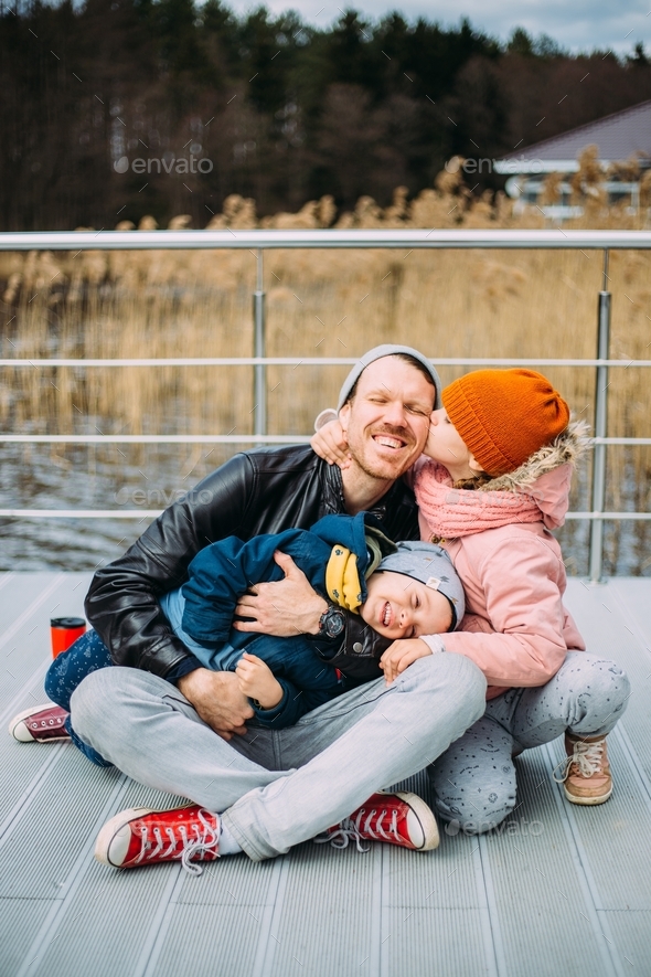 Happy family man, his daughter and son relaxing in nature Stock Photo ...