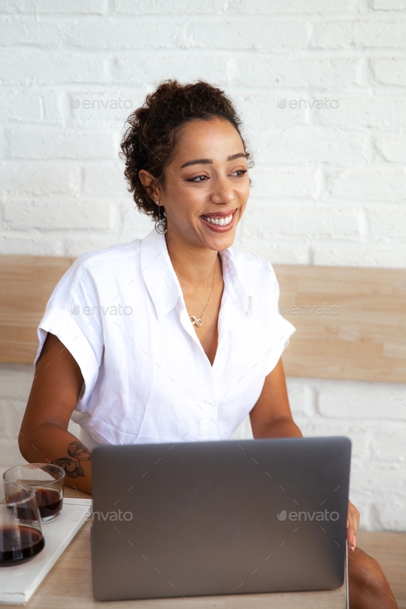 Beautiful happy woman working remotely using laptop. Diverse concept ...