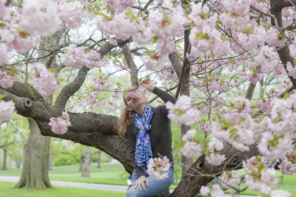 Young millennial woman enjoying spring time outdoor in the park in New ...