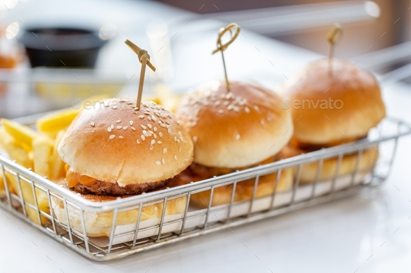 Mini burgers with french fries served at the bar, finger food, closeup ...