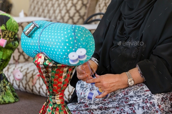 Emirati woman is making traditional embroidery talli, hands in frame ...