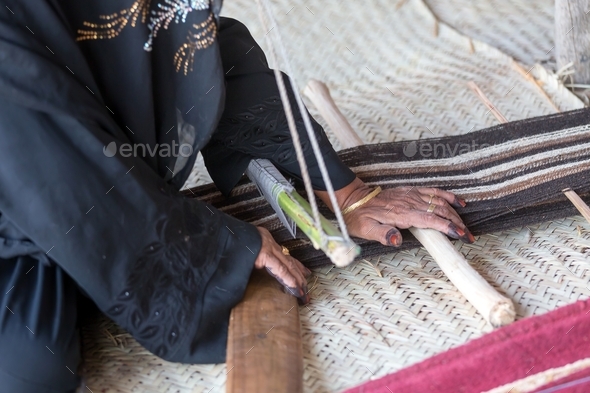 Hands of an old Emirati lady using traditional weaving machine Stock ...