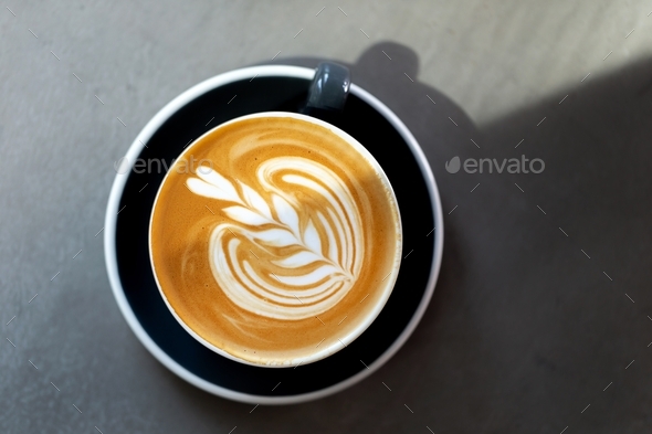 Overhead shot of cafe latte art, closeup macro with distinctive shadow ...