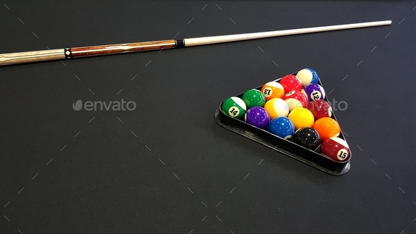 Black pool table with colored balls and the wooden cue Stock Photo by ...