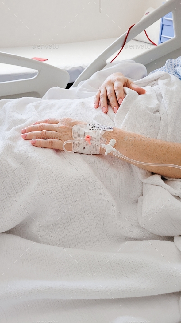 Woman in a hospital bed after surgery, hands in frame Stock Photo by ...