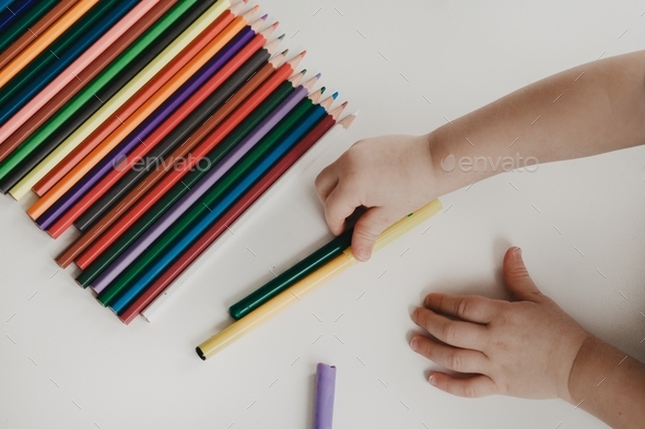 Little child preschoo take a pencil Stock Photo by Katerina_zhiltsova