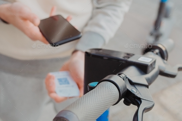 A man scans an electric scooter qr-code for rent Stock Photo by ...