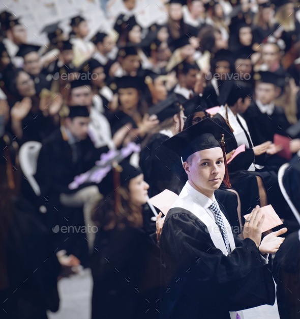 Young man clapping at graduation ceremony Stock Photo by JulieAlexK