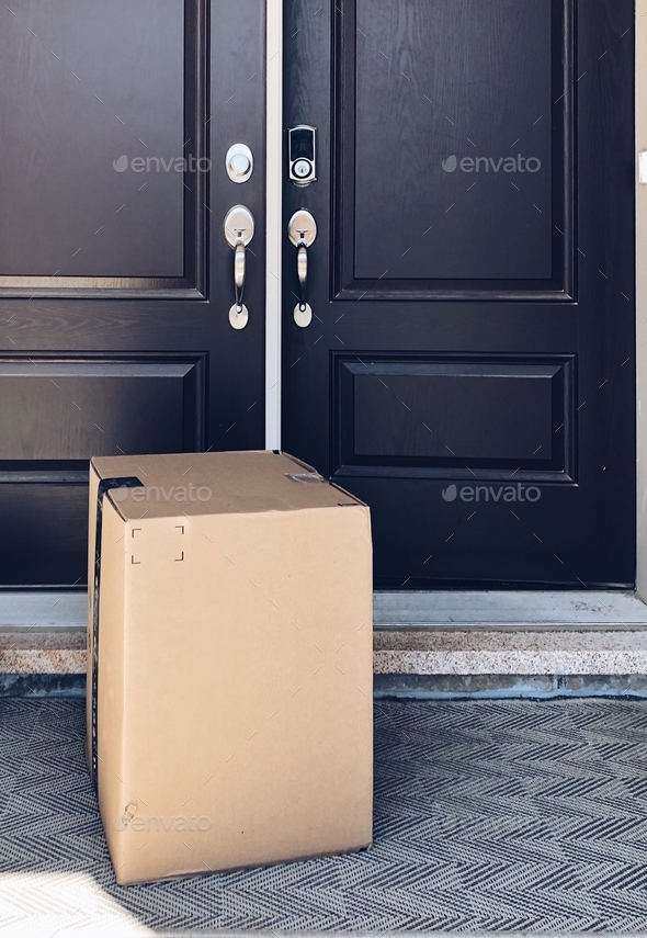 Large parcel on a front porch of a house Stock Photo by JulieAlexK
