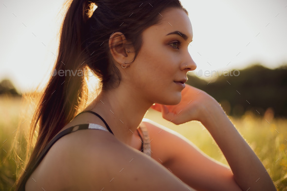 Side profile of young brunette woman at golden hour Stock Photo by ...