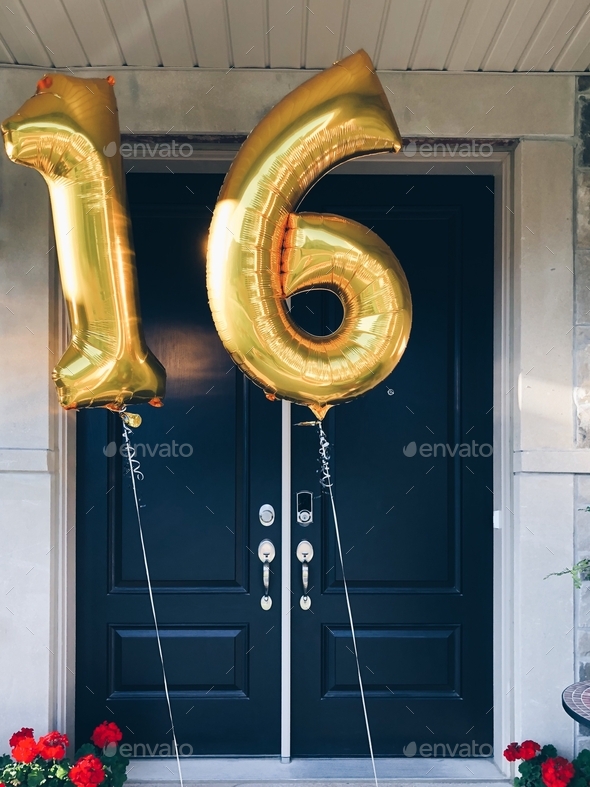 Sweet 16 sixteen gold number helium balloons in front of a house front ...