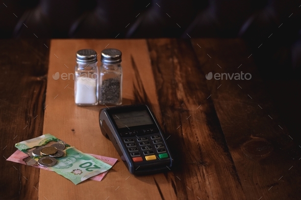 Cash money or tip and payment terminal on a restaurant table Stock ...