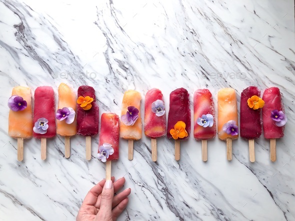 Woman’s hand is pulling one of the lined up in a row bright and ...