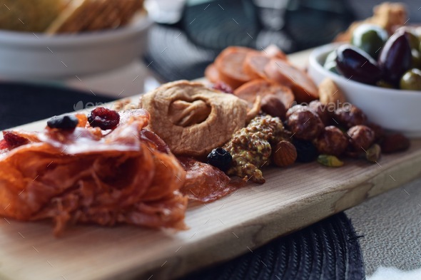 Cured meats and dried fruits Charcuterie board at a restaurant Stock ...