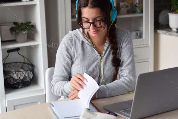 Young teenage girl student using notebook to write notes while studying ...