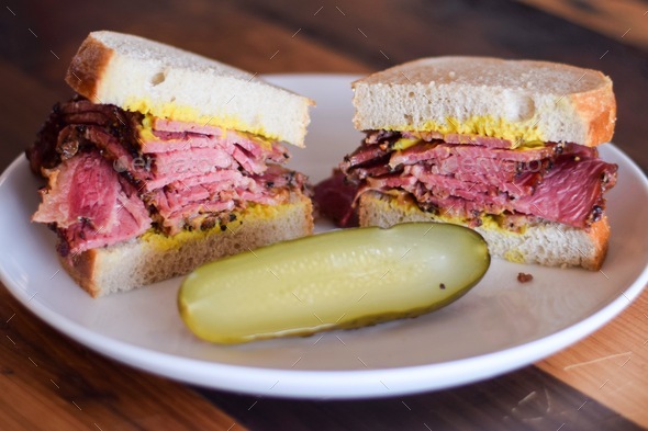 Montreal smoked meat sandwich with a pickle Stock Photo by JulieAlexK