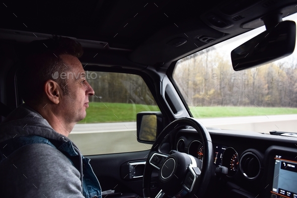 Man driving in a car on a highway Stock Photo by JulieAlexK | PhotoDune