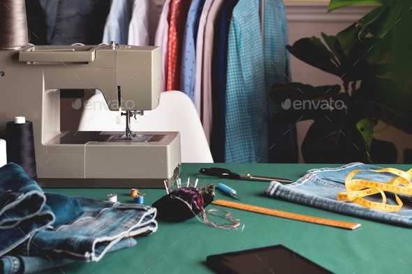 Workspace table with sewing machine and alterations supplies Stock ...