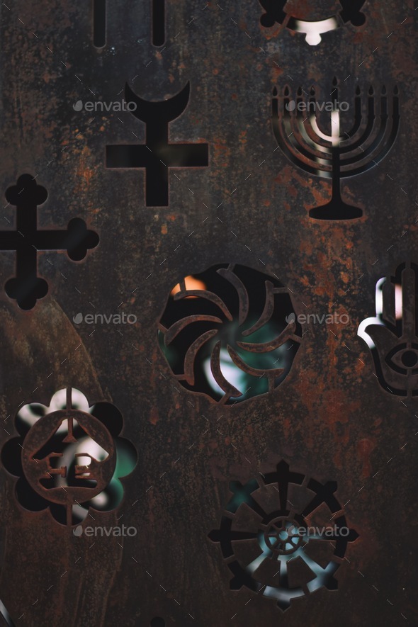 Religious and spiritual symbols cut out in a rustic metal Stock Photo ...