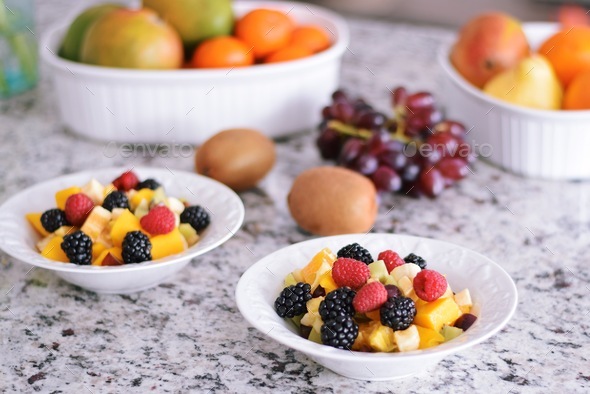 Bowls of freshly cut fruit salad on a granite kitchen countertop Stock ...