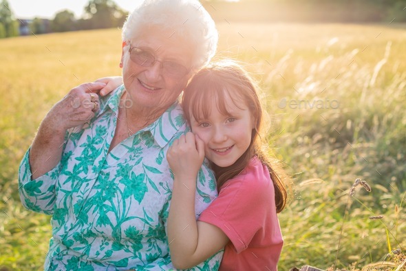 Grab and grand daughter closely hugging in sunshine Stock Photo by ...