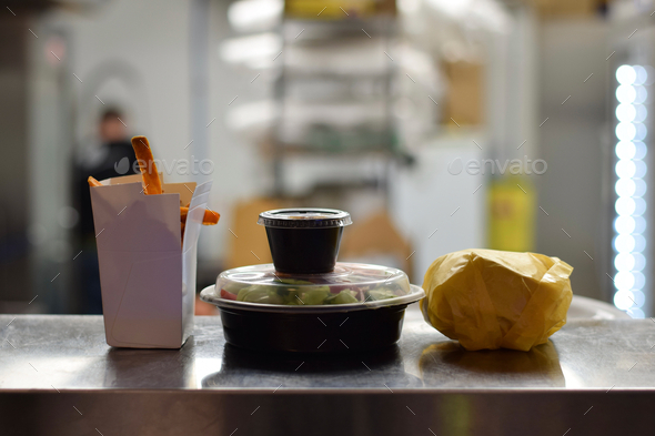 Take out order containers on a restaurant take out window, salad ...